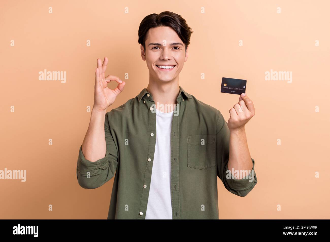 Portrait of cheerful nice person hold debit plastic card demonstrate ...