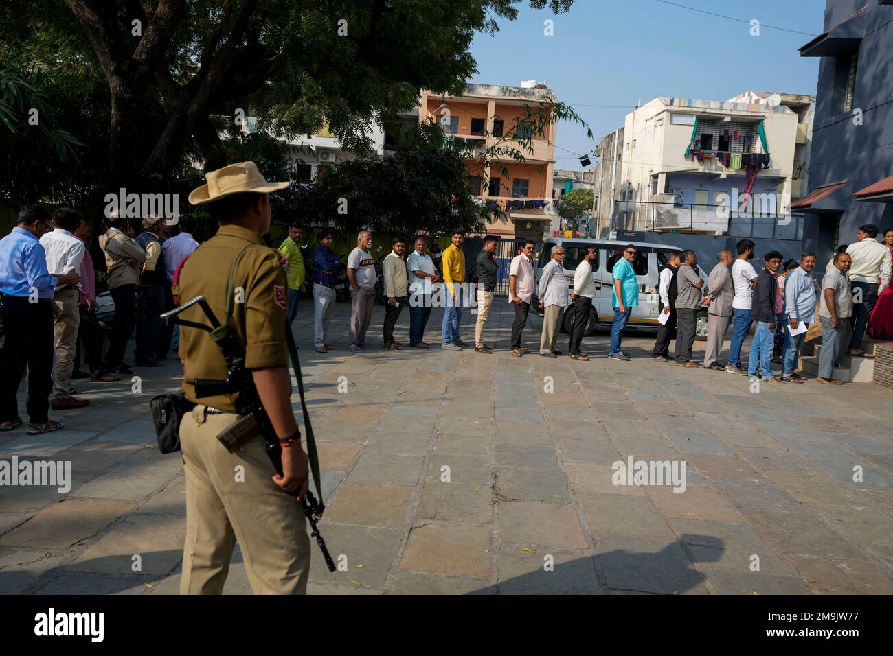 People stand in queue to cast their vote during the second phase of ...