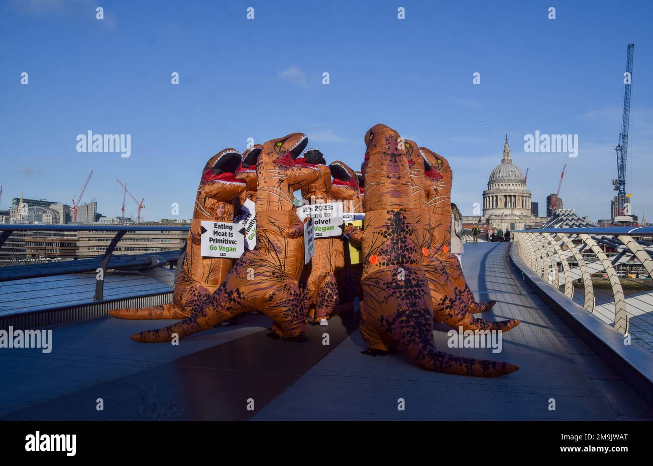 London, UK. 18th January 2023. PETA activists wearing dinosaur costumes urge people to go vegan ...