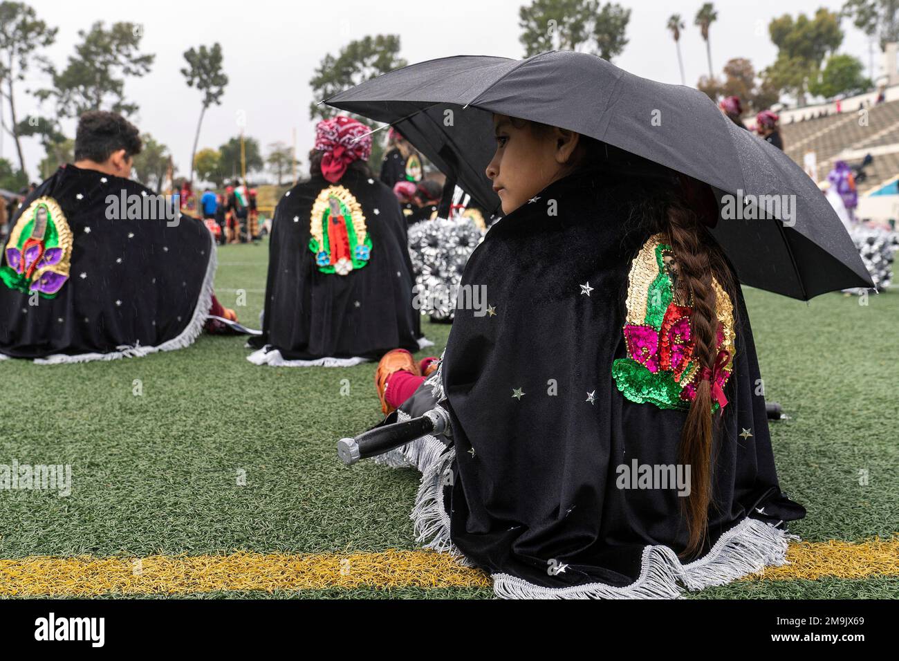 Young members wear decorated cloaks with the image of Our Lady of ...