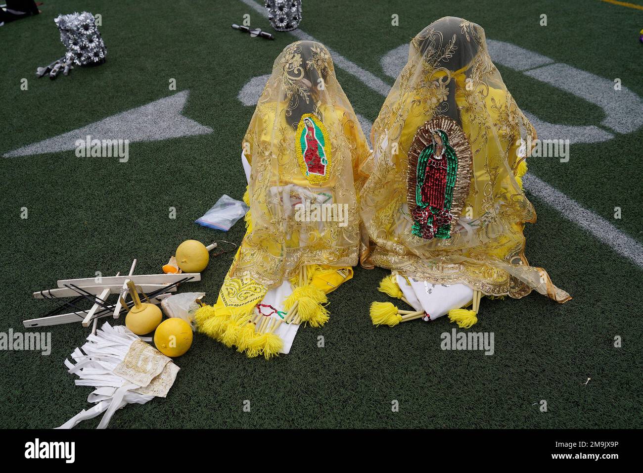 Young members wear decorated cloaks with the image of Our Lady of ...