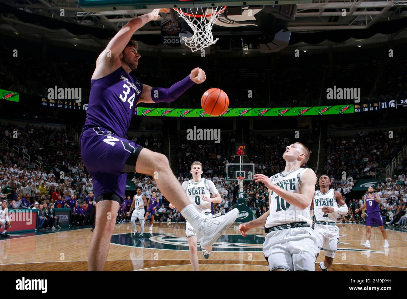 Northwestern's Matthew Nicholson, left, dunks against Michigan State's ...