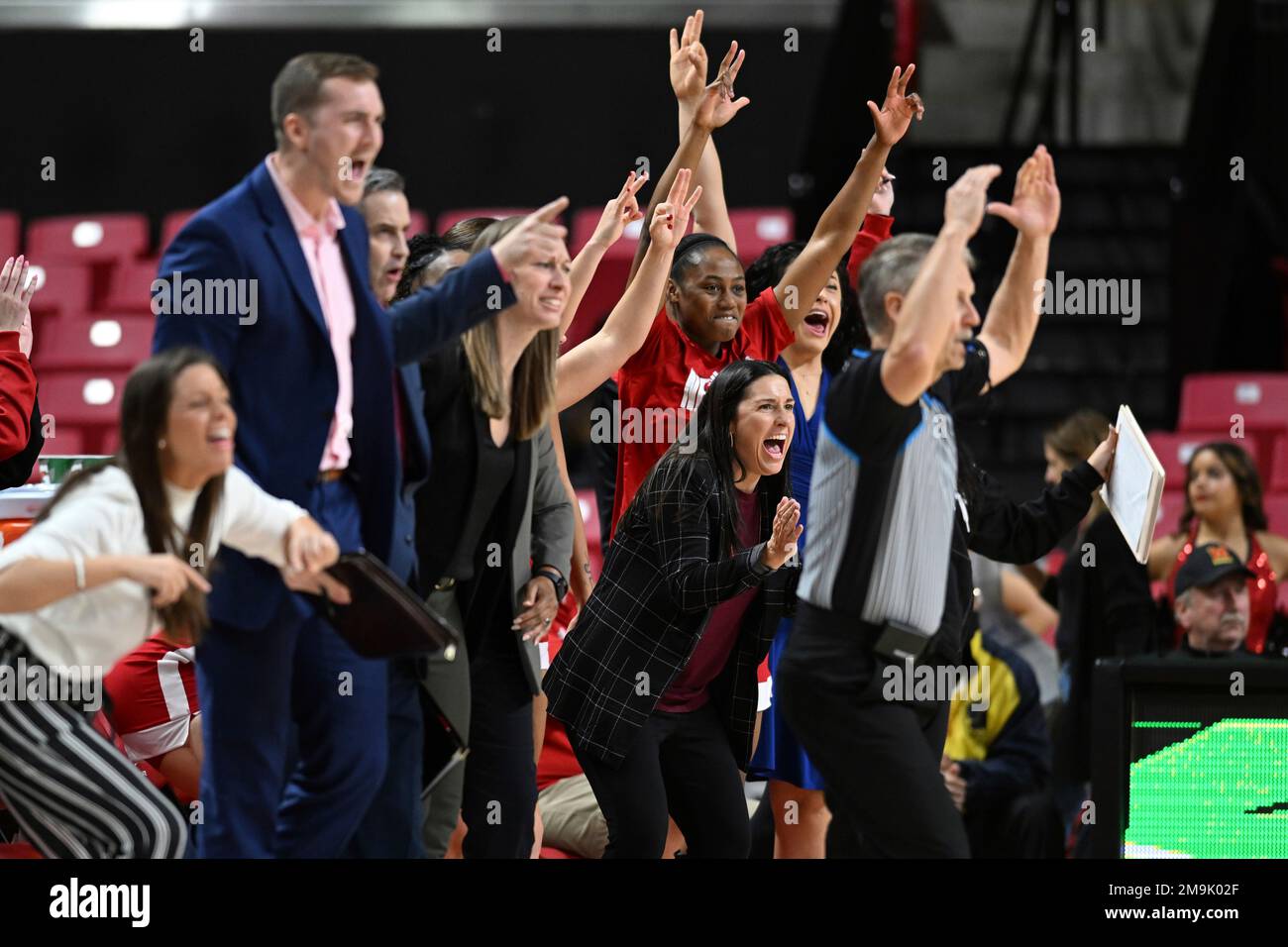 Nebraska head coach Amy Williams , center, and the Nebraska bench cheer ...