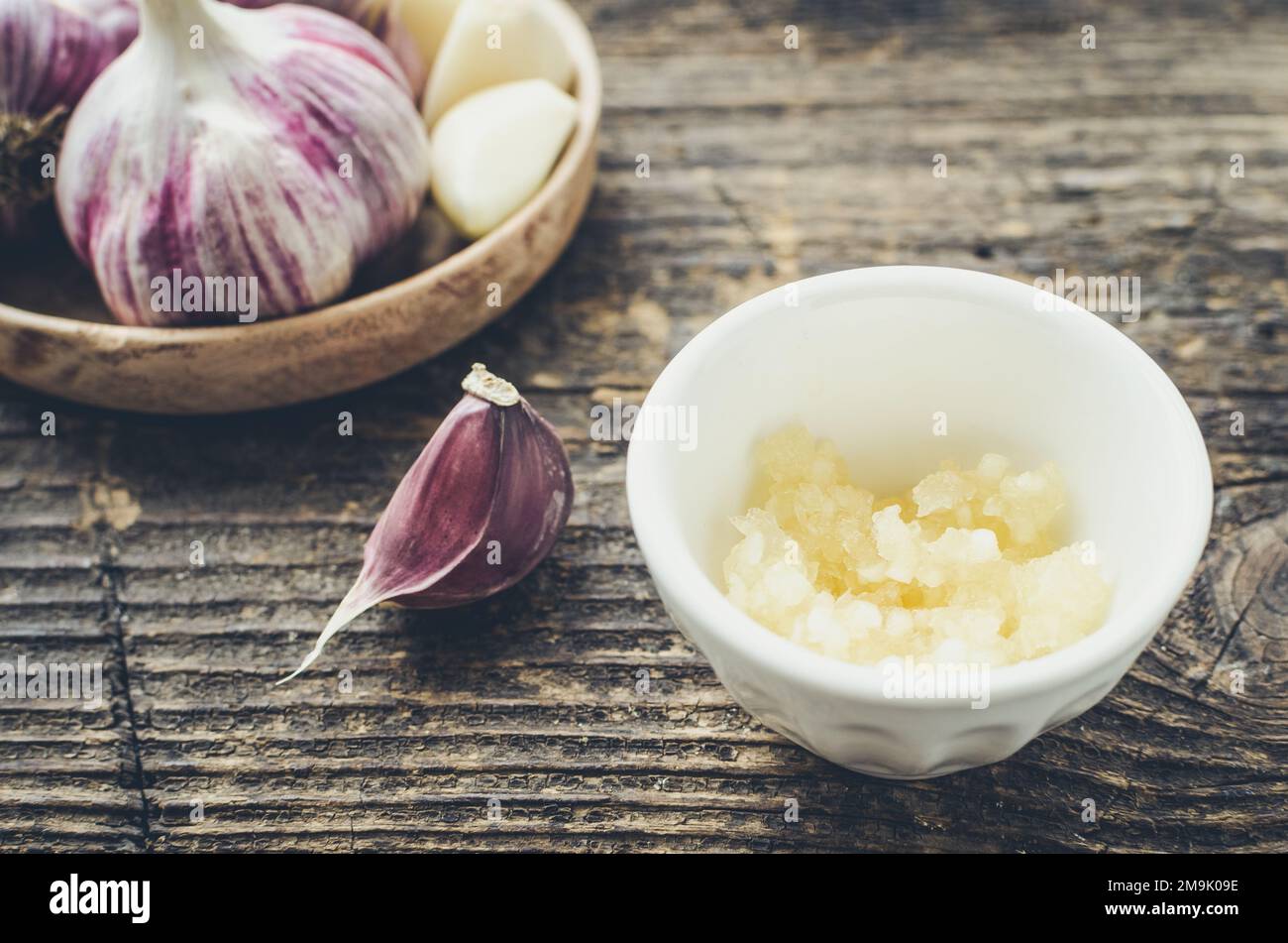 Rustic style garlic on vintage wooden background. Fresh young peeled ...