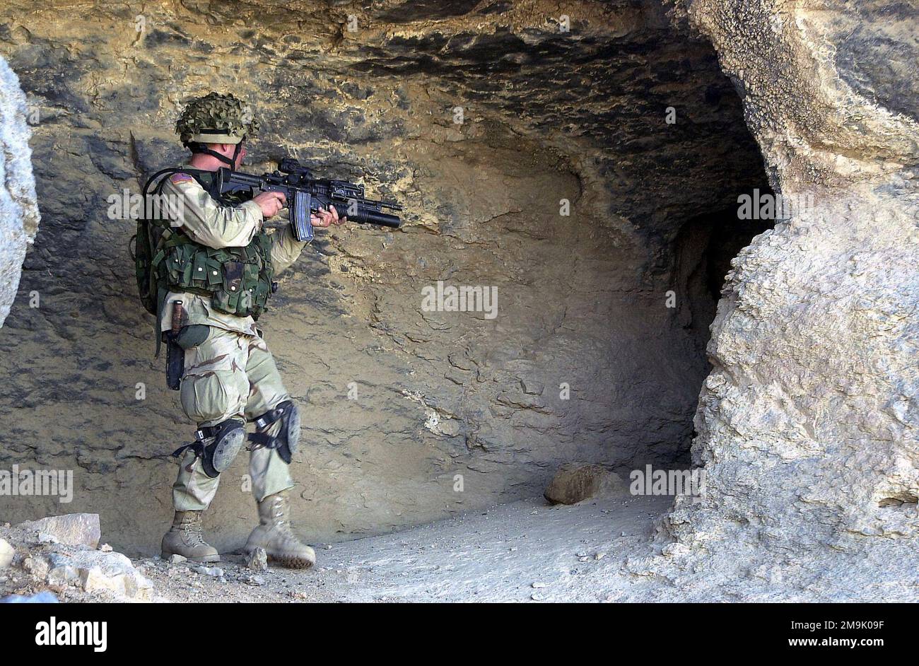 US Army (USA) Private First Class (PFC) Jason Ketchum aims his 5.56mm ...