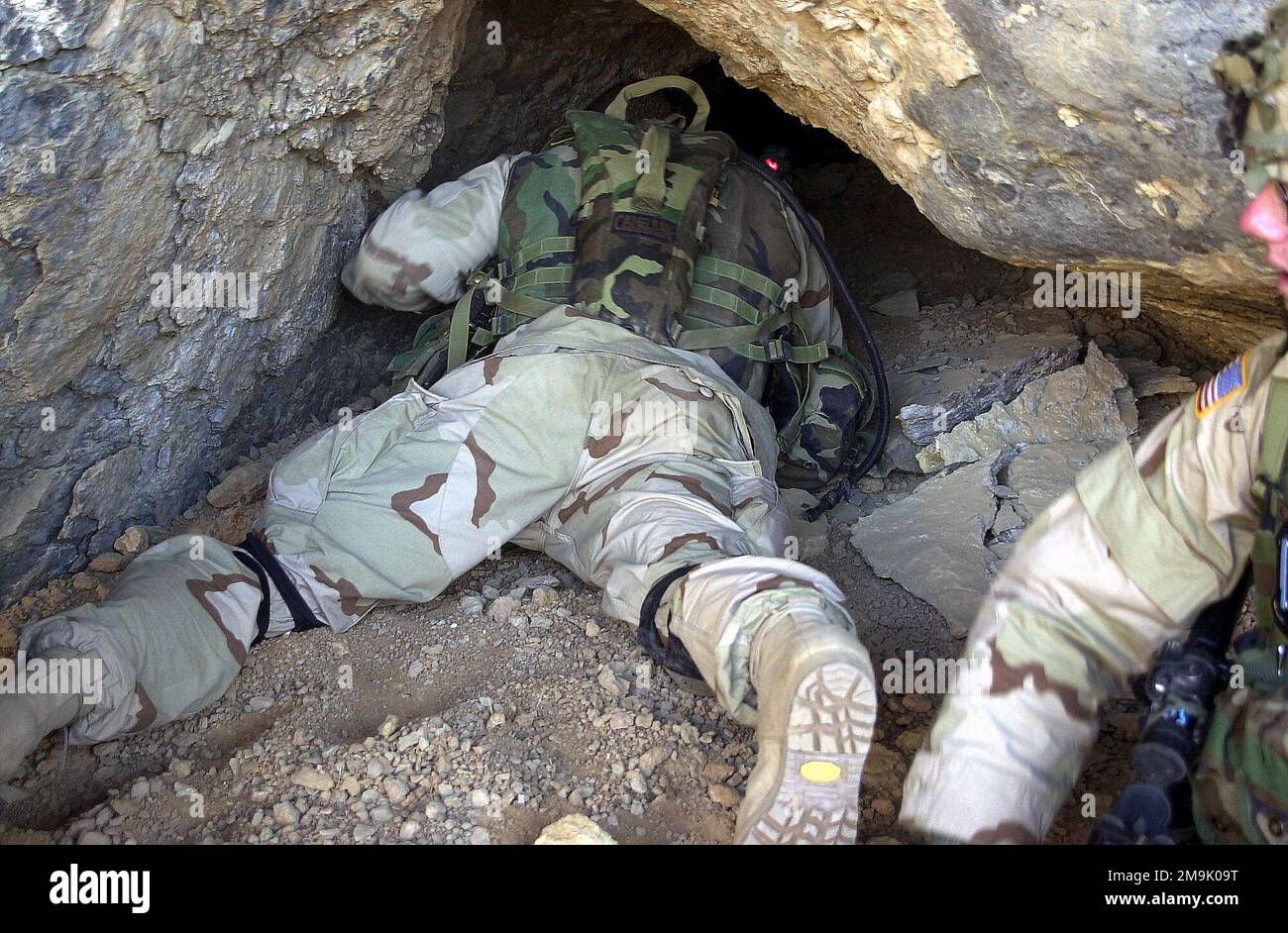 US Army (USA) Private First Class (PFC) Jason Ketchum crawls into a ...