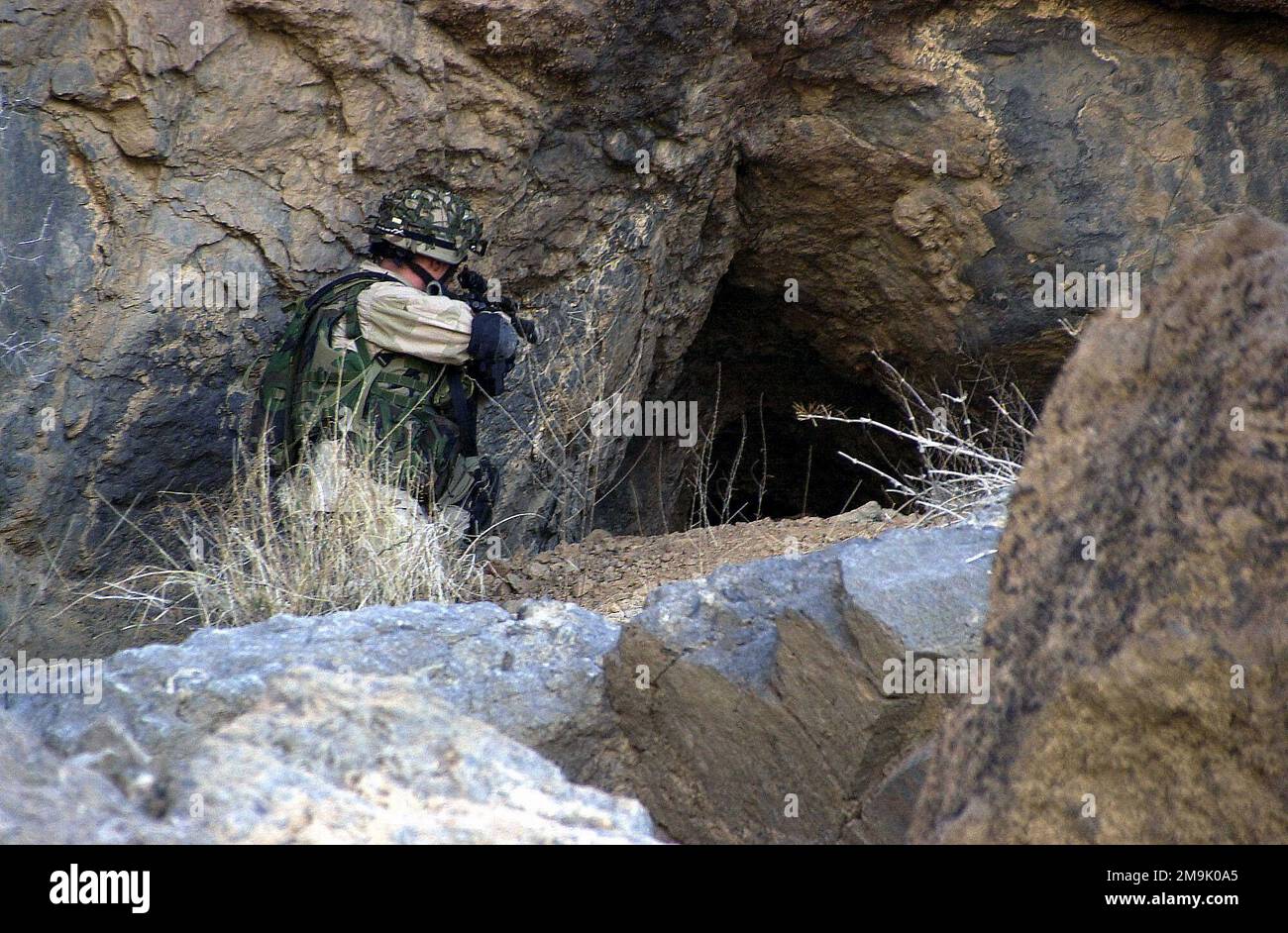US Army (USA) Sergeant (SGT) Davis Kasanof aims his 5.56mm M4 Carbine ...