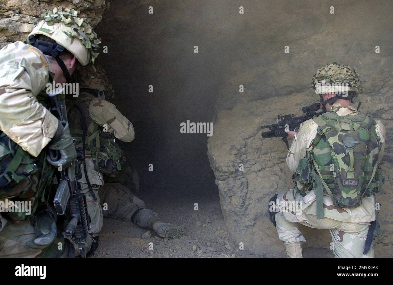 With their 5.56mm M4 Carbine rifles at the ready, Sergeant (SGT) Davis ...