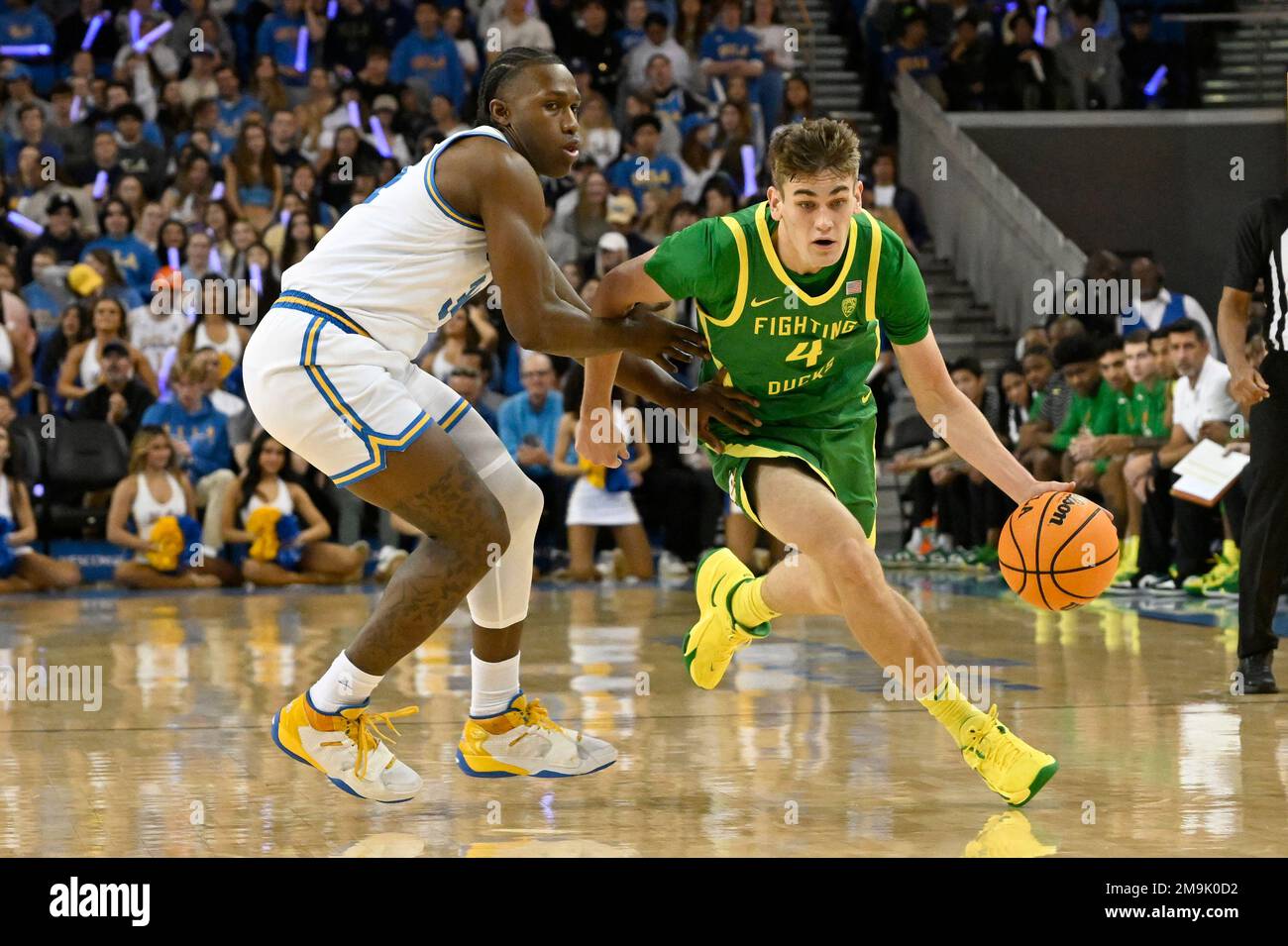 Oregon guard Brennan Rigsby, right, drives past UCLA guard David ...