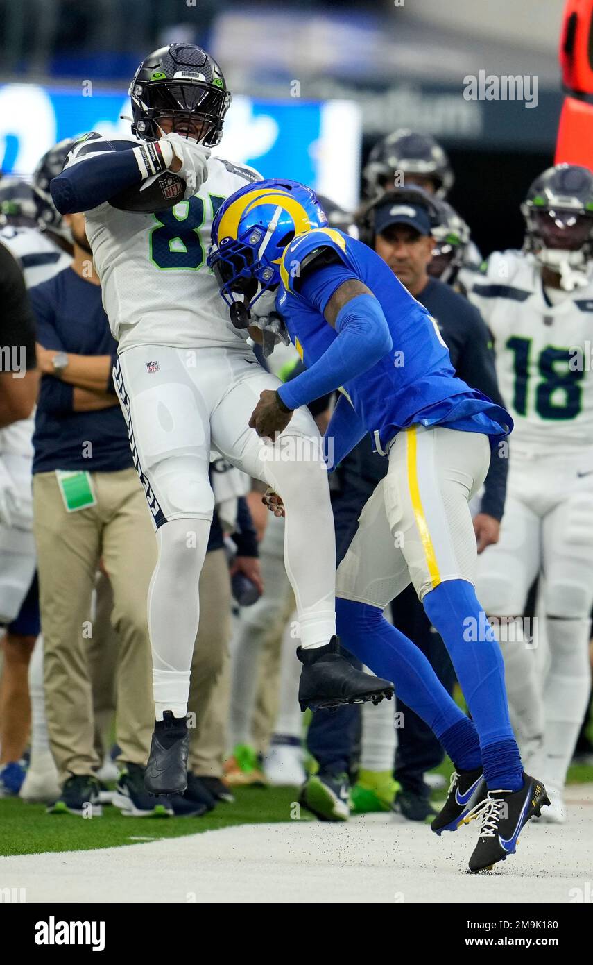 Seattle Seahawks tight end Noah Fant, left, is knocked out of bounds by ...
