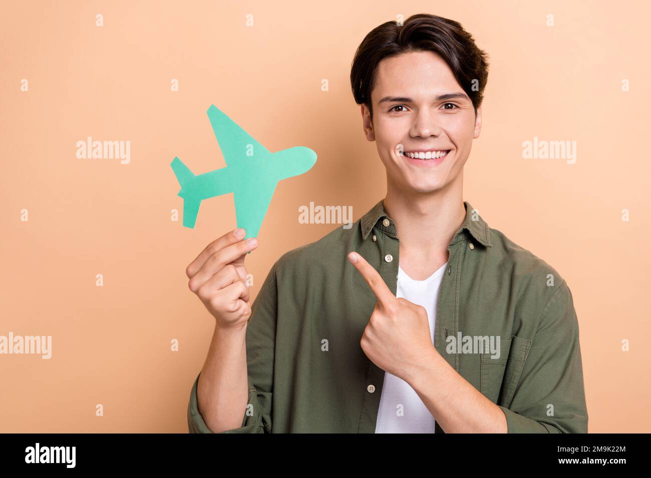 Photo portrait of young man student hold paper blue airplane directing ...