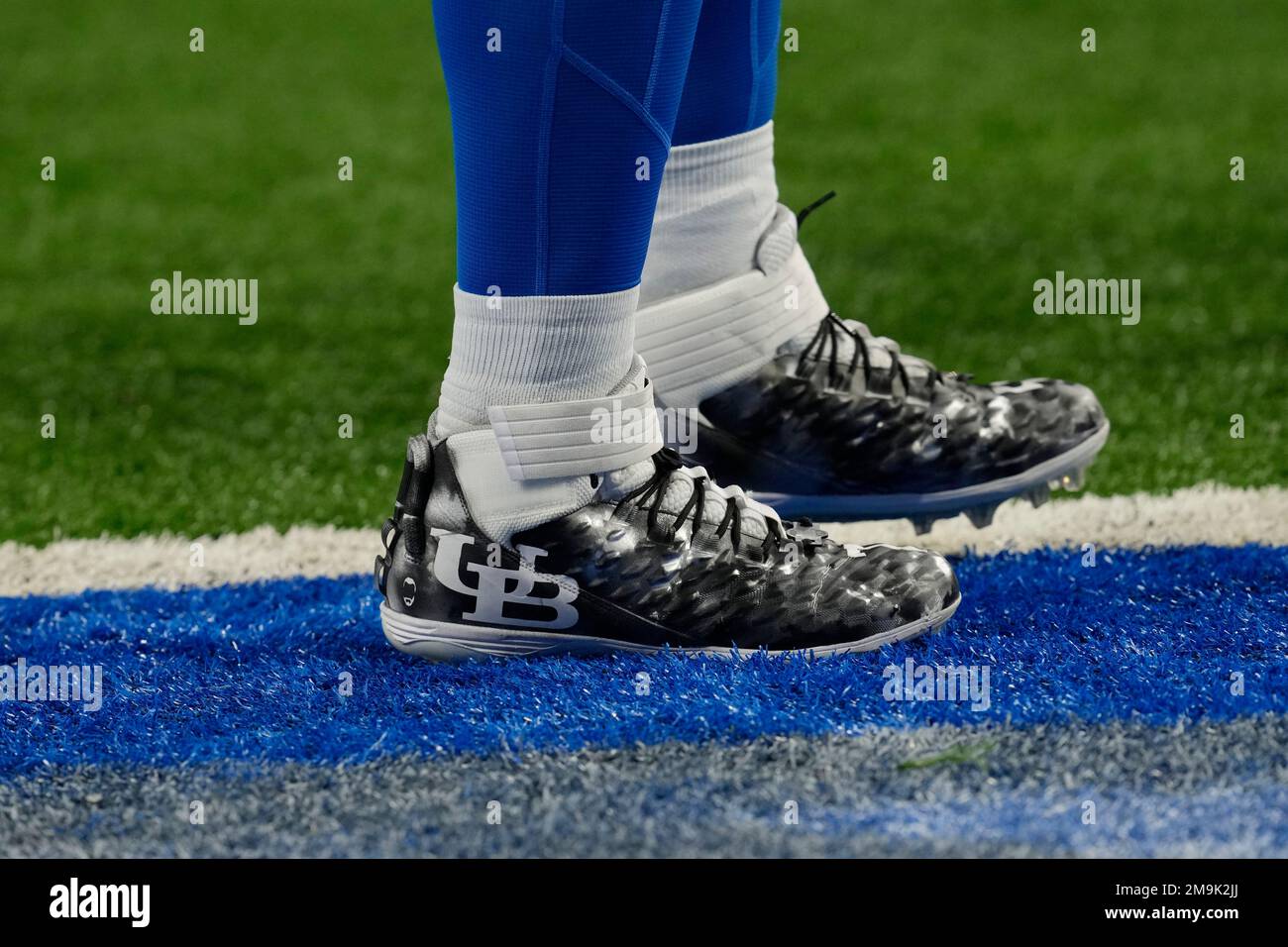 Detroit Lions guard Kayode Awosika wears cleats highlighting gun ...