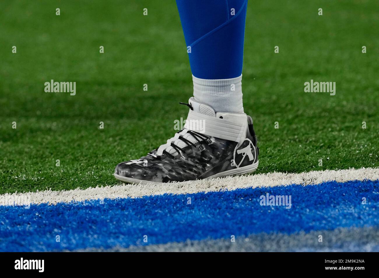 Detroit Lions guard Kayode Awosika wears cleats highlighting gun ...