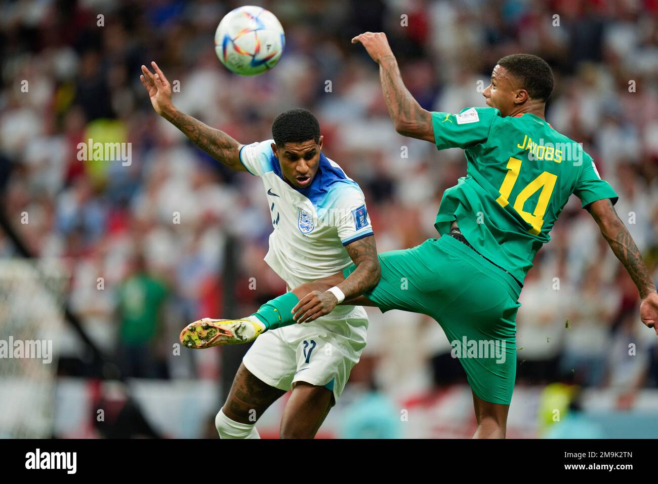 England's Marcus Rashford, left, andSenegal's Ismail Jakobs go for a ...