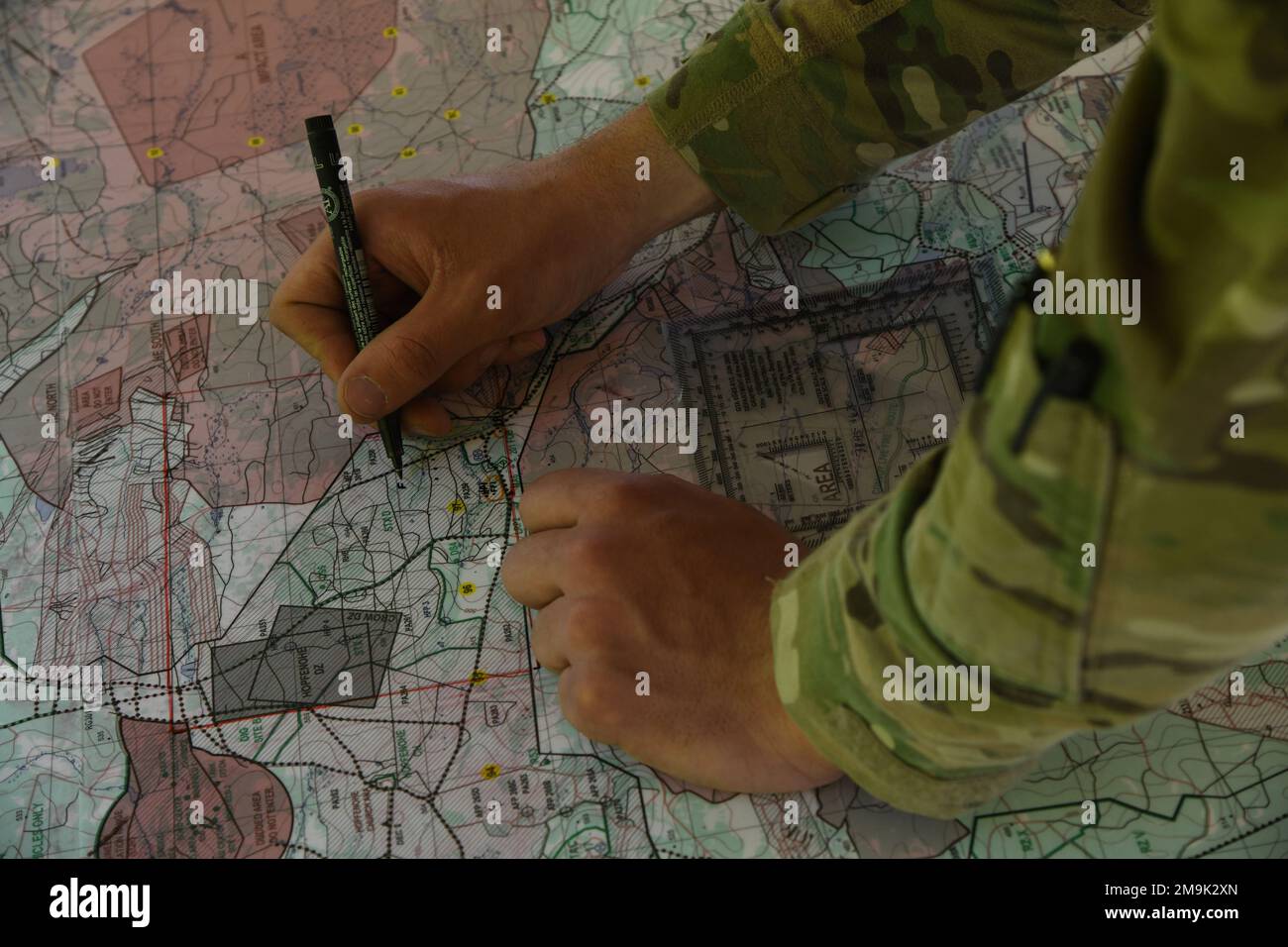A U.S. Soldier assigned to the 41st Field Artillery Brigade plots ...