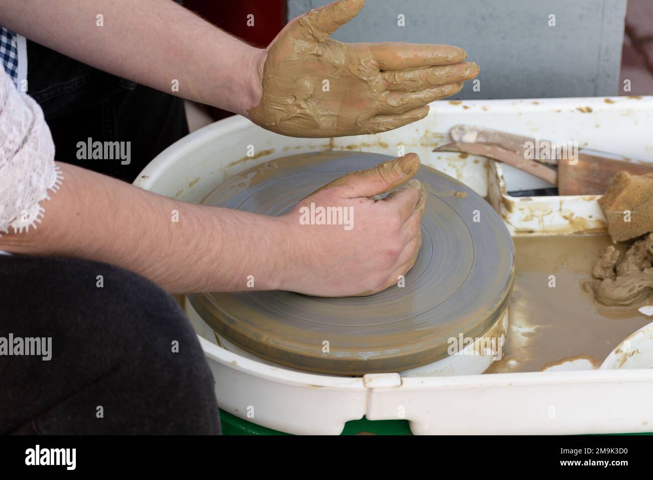 Making A Clay Pot. Potter working on potters wheel making ceramic pot ...