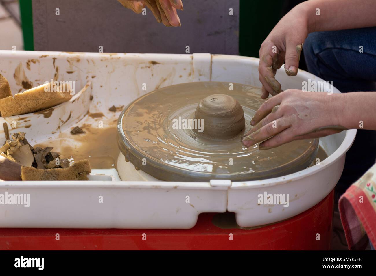 Making A Clay Pot. Potter working on potters wheel making ceramic pot ...