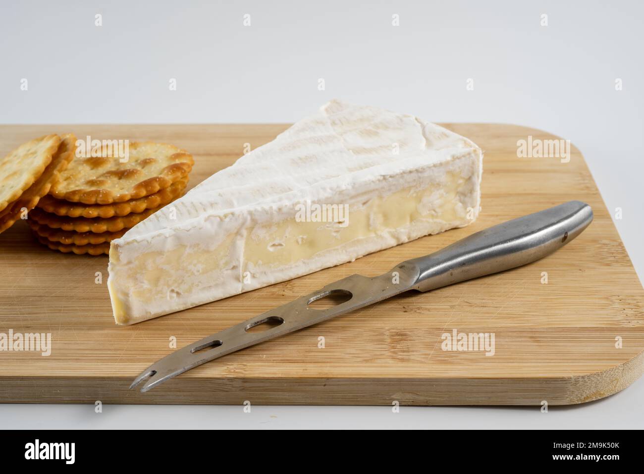large slice of french brie soft cheese with white mold crust thin ...