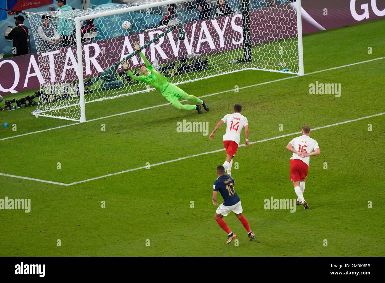 France's Kylian Mbappe, right, fights for the ball with Poland's Matty ...
