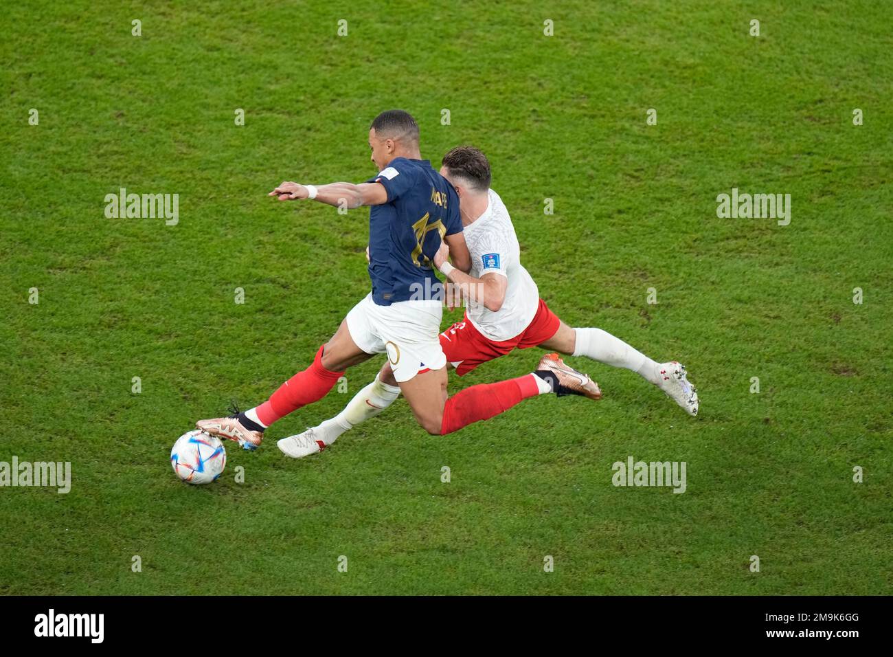 France's Kylian Mbappe, left, fights for the ball with Poland's Matty ...