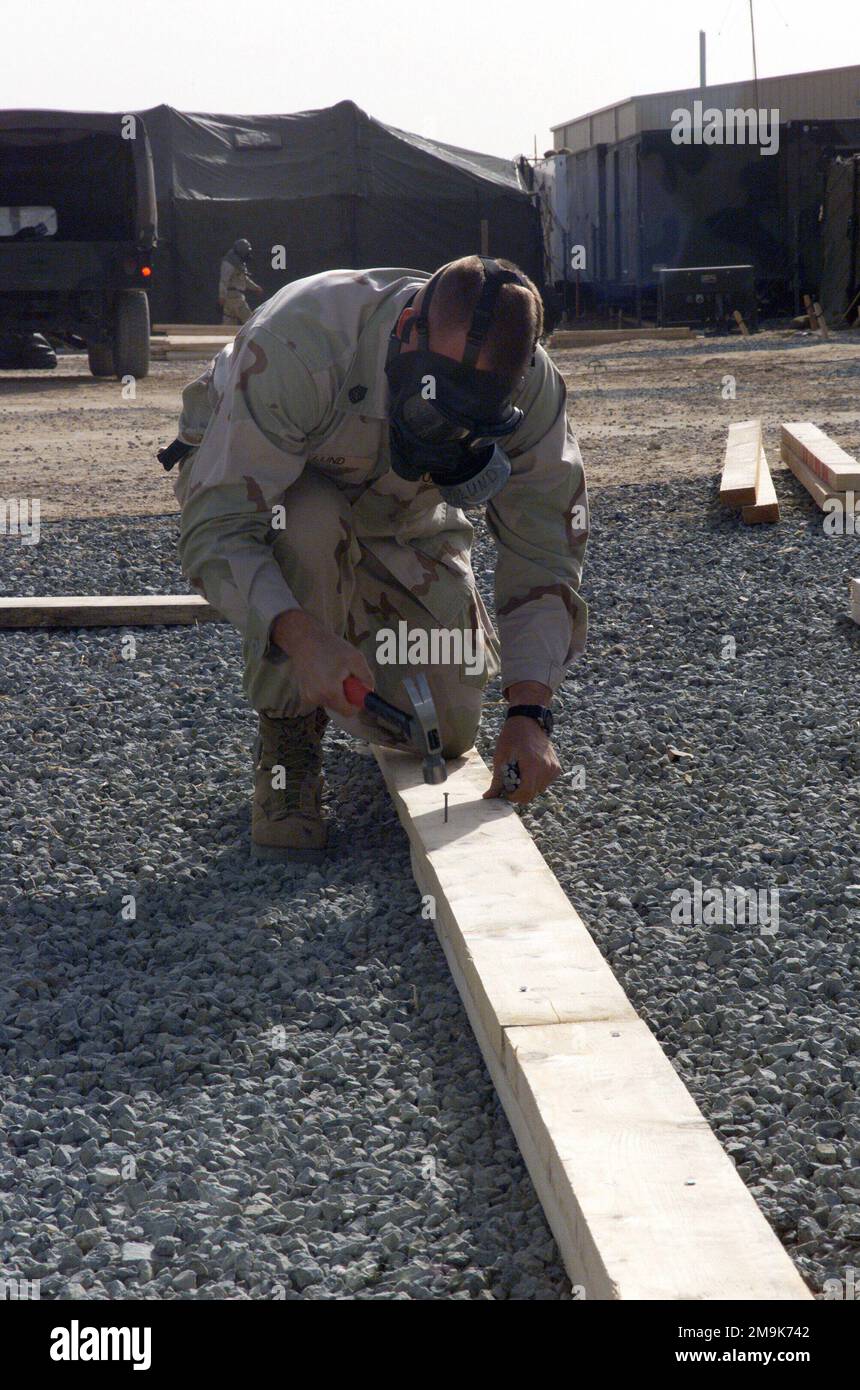 GUNNERY Sergeant (GYSGT) Michael Lund constructs tents during a gas ...