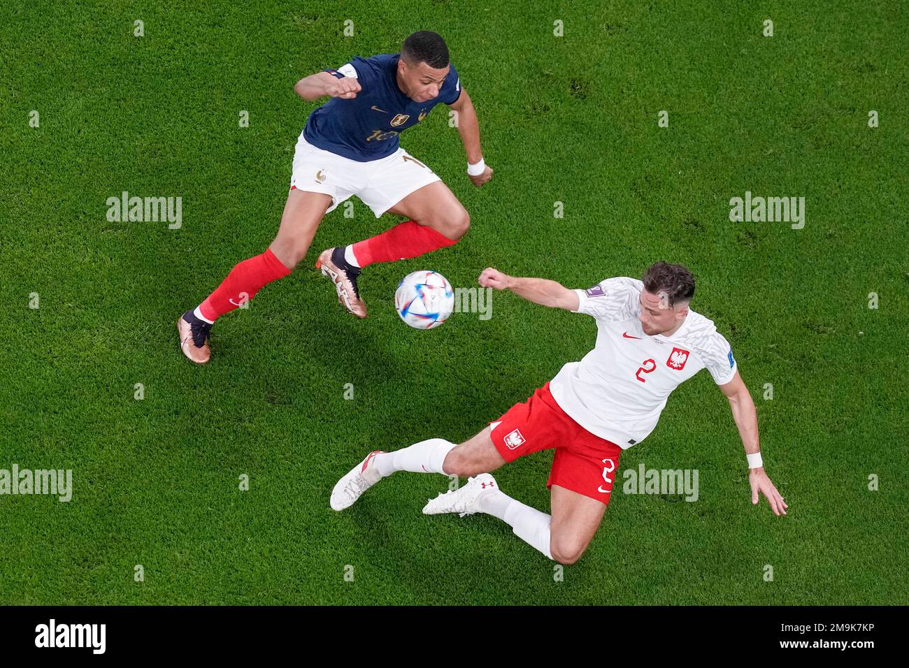 France's Kylian Mbappe, left, fights for the ball with Poland's Matty ...