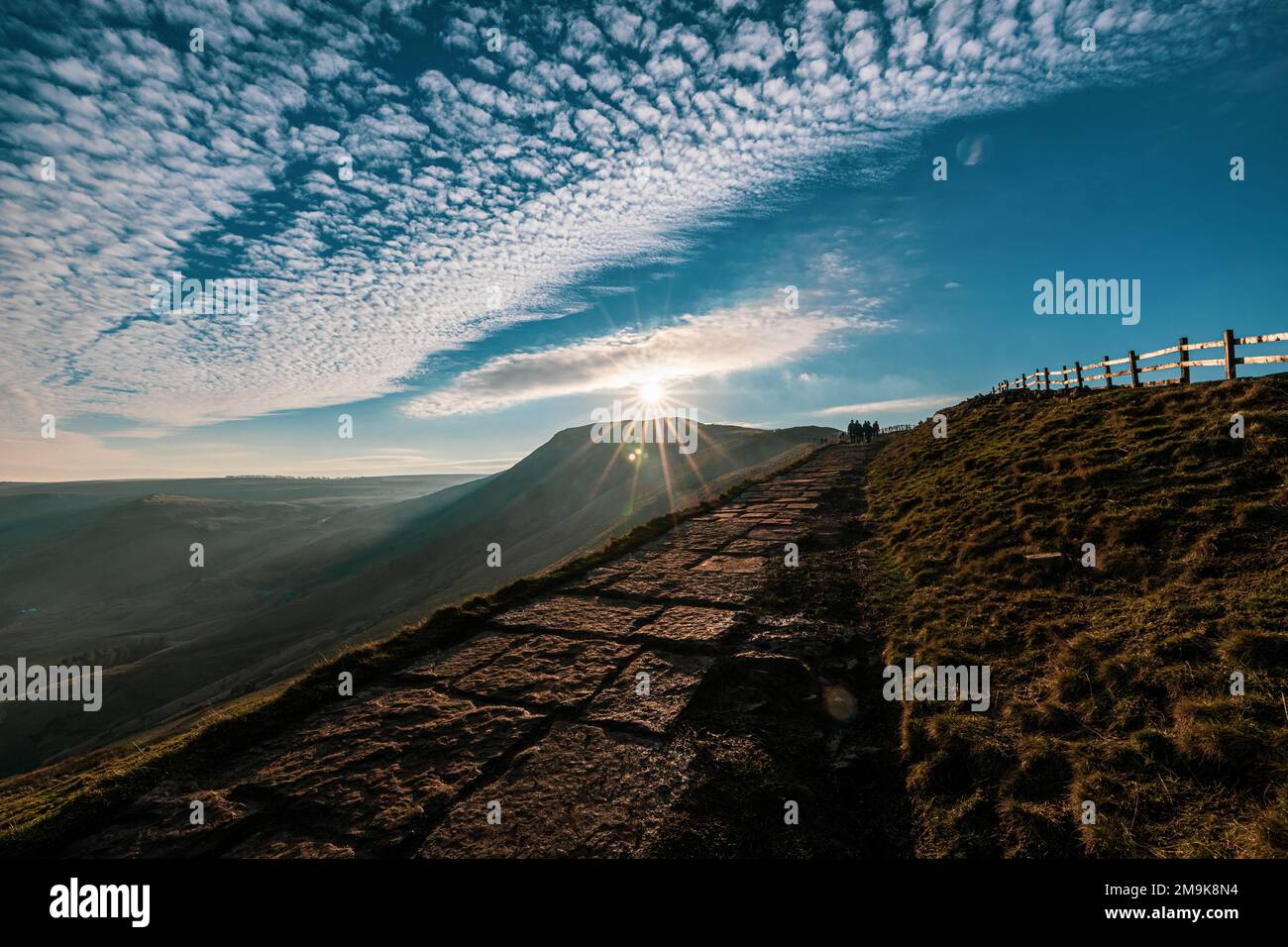 The Mam Tor hill and ridge walk with sunset over the mountain peak with ...
