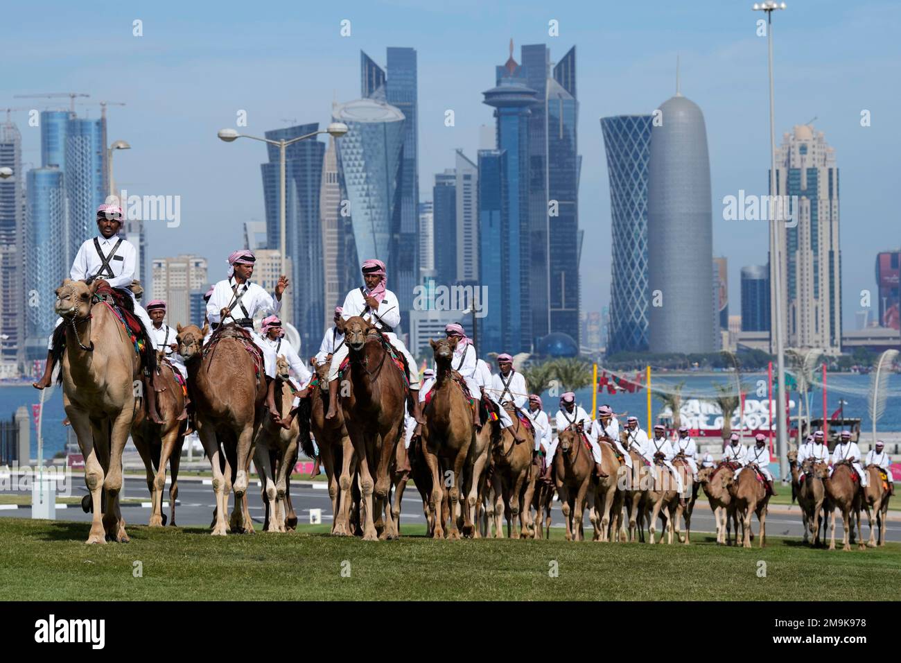 Guards ride their camels outside the Amiri Diwan in Doha, Qatar ...