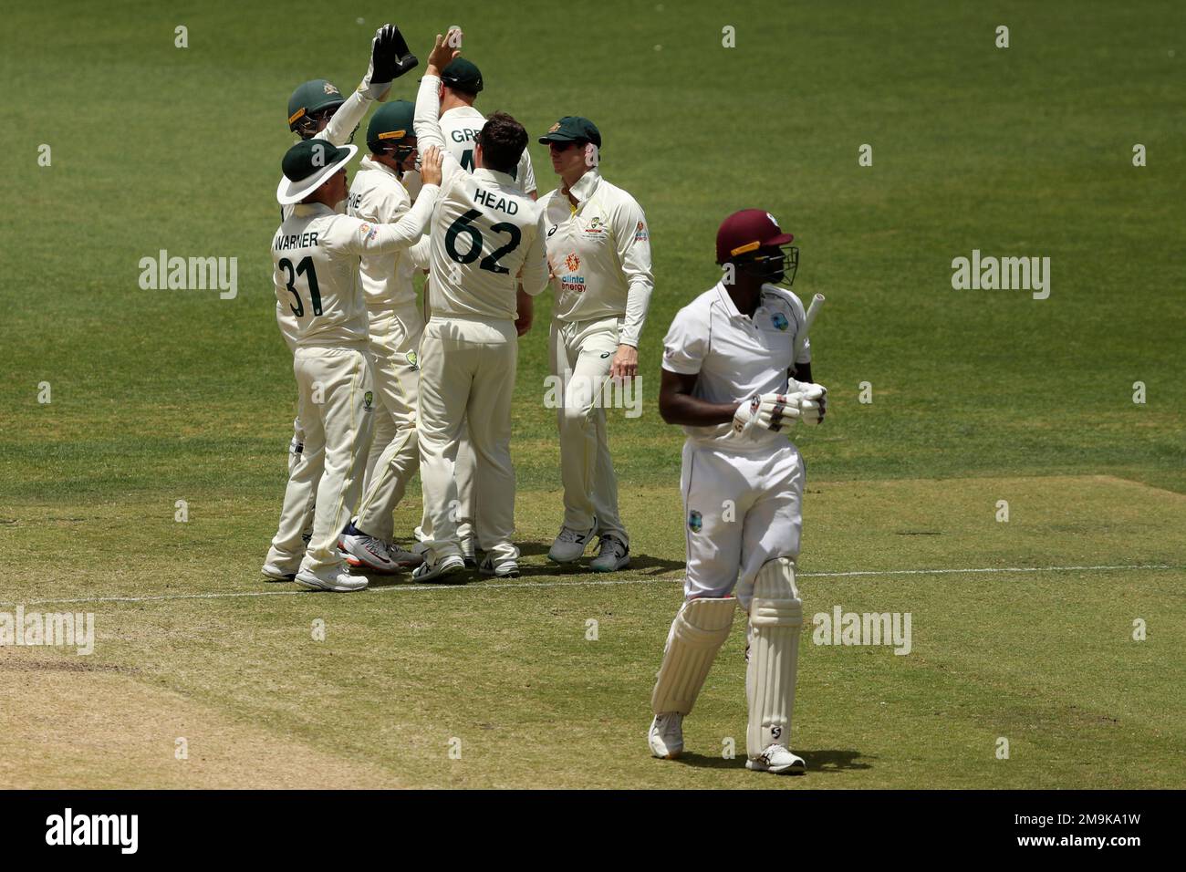 Australia's Travis Head, center, celebrates with teammates after taking ...
