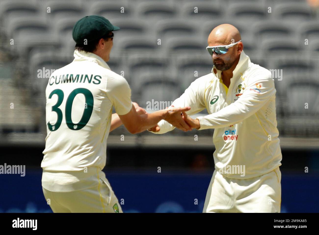 Australia's Nathan Lyon, right, celebrates with teammate Pat Cummins ...