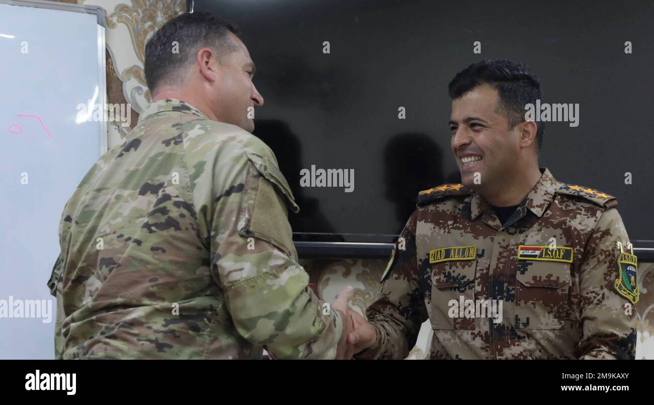 An Iraqi Counter Terrorism Service (ICTS) Officer shakes hands with a ...