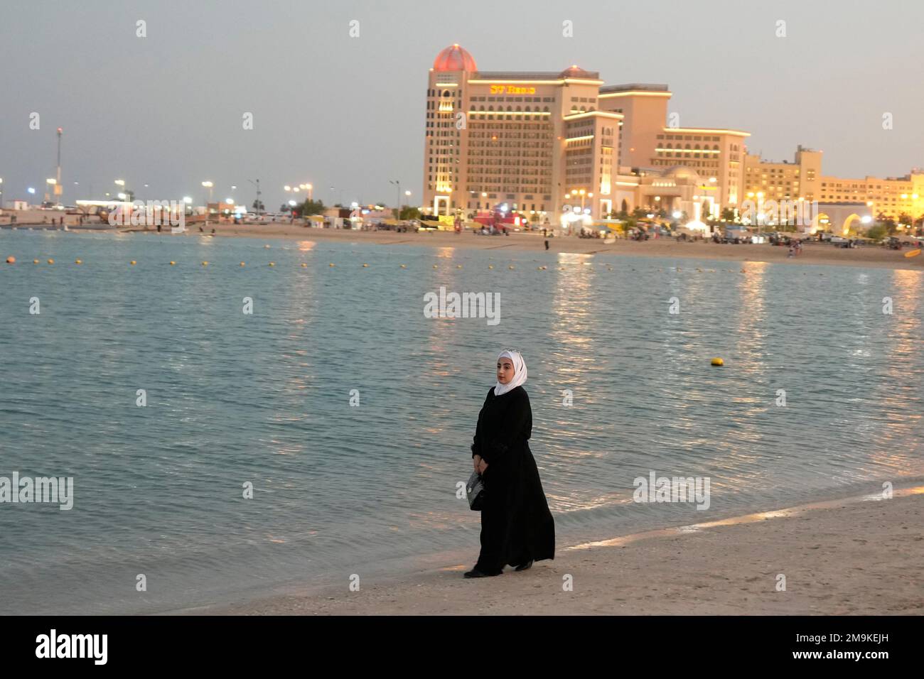 A woman stands at Katara Beach in Doha, Qatar, Saturday, Dec. 3, 2022 ...