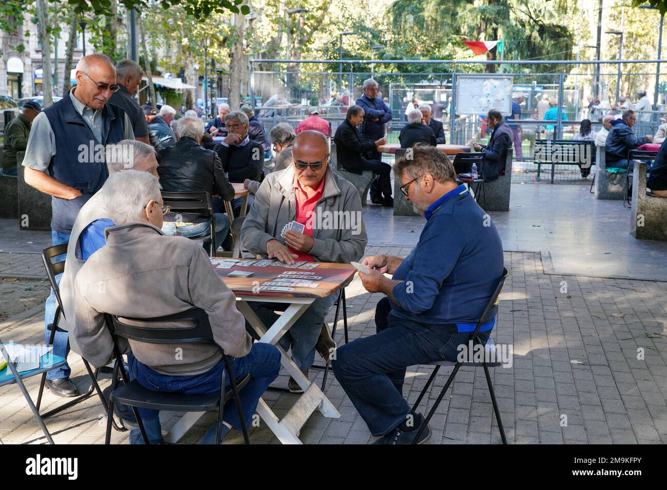 Elders playing cards in a local park in Milano (Italy Stock Photo - Alamy