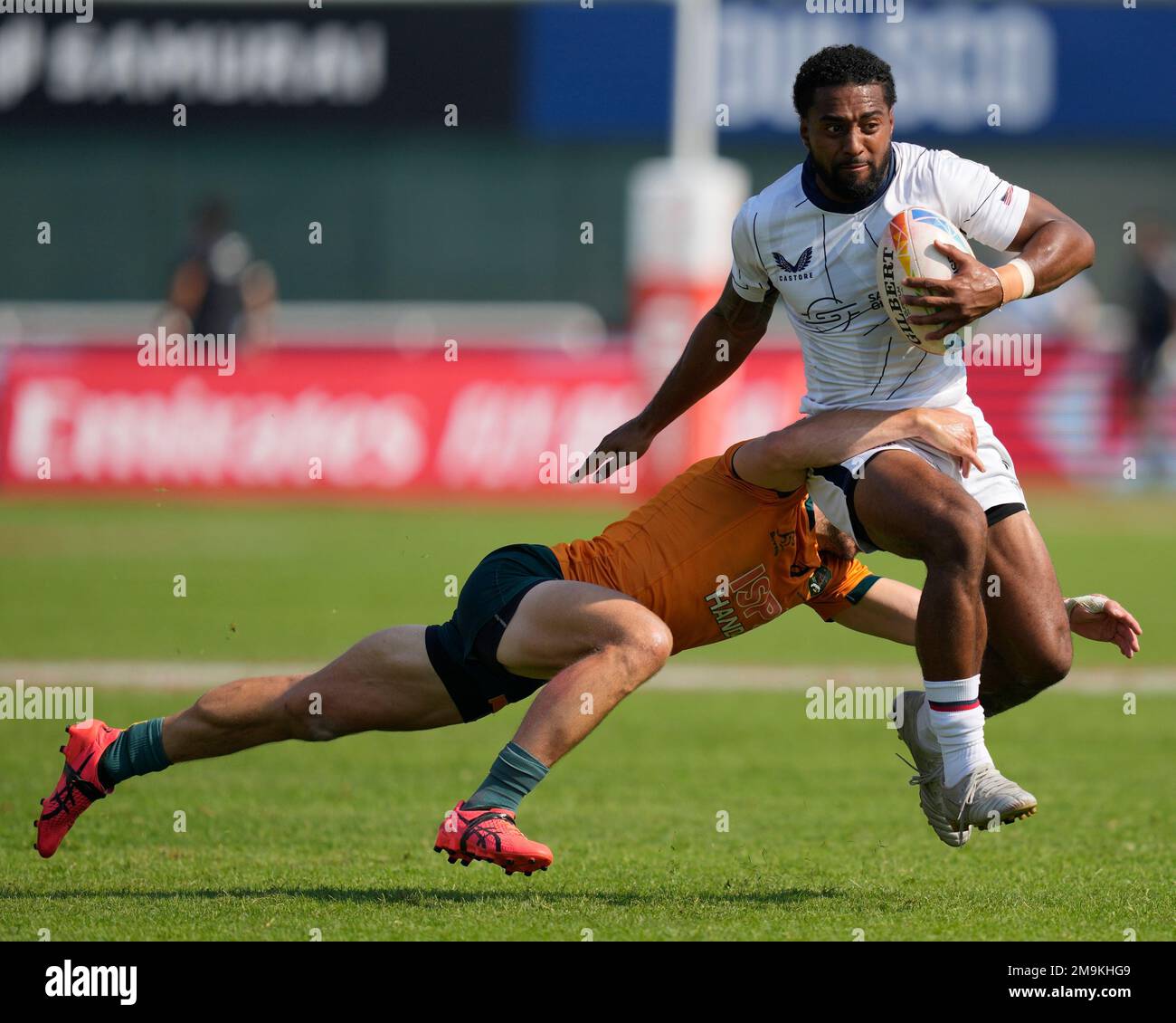Marcus Tupuola from the U.S. is tackled by Australia's Josh Turner ...