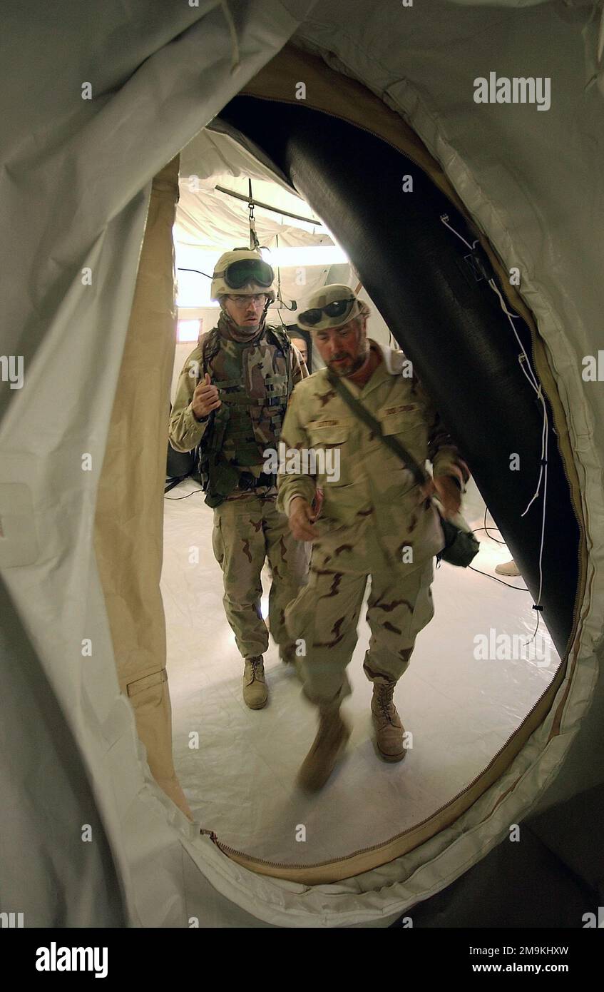 US Navy (USN) Hospital Corpsman Second Class (HM2) Thomas Miller (left ...