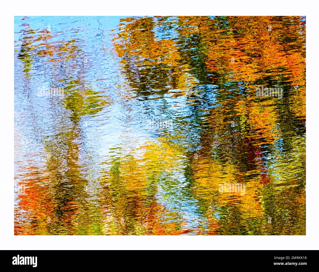 Abstract photograph of ripples and reflections of autumn trees in water ...