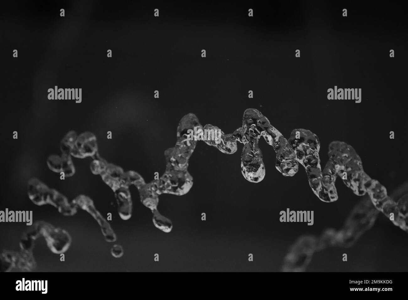 Close up on water frozen in time with natural low light as it moves ...