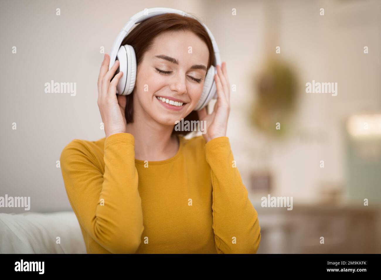 Young happy woman using headphones hi-res stock photography and images - Alamy