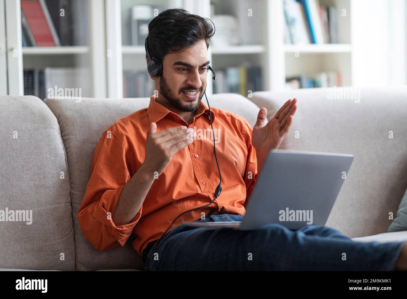 Arab man CEO working from home, using laptop and headset Stock Photo ...