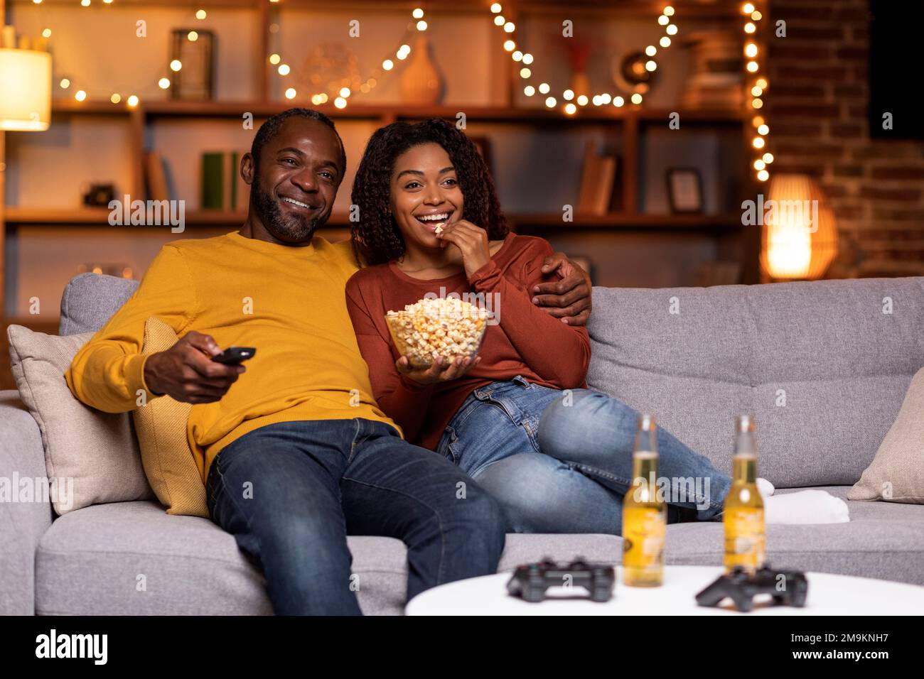 Happy relaxed black spouses watching movie at home Stock Photo - Alamy