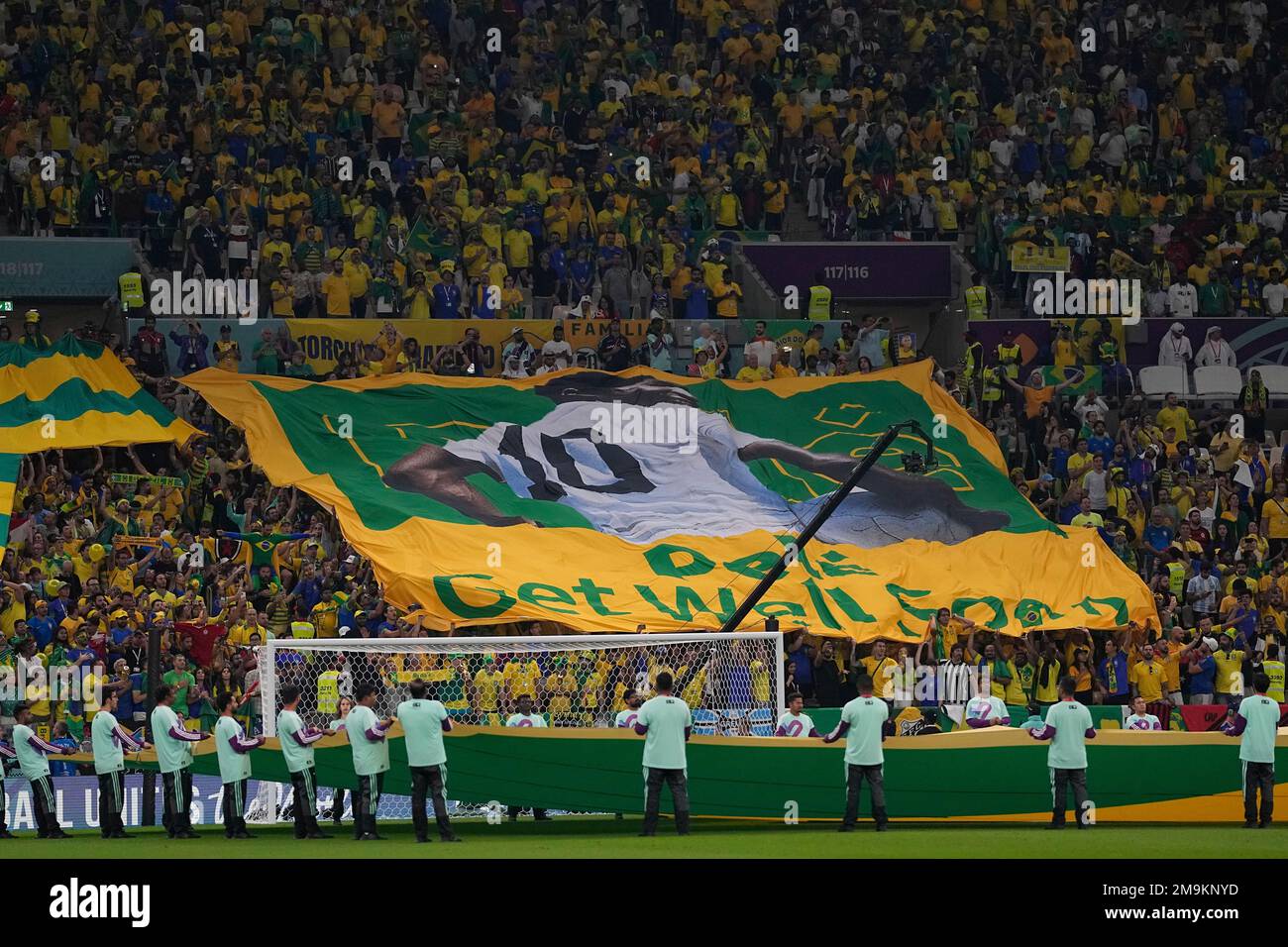 Soccer fans hold a giant Brazilian flag with picture of former ...
