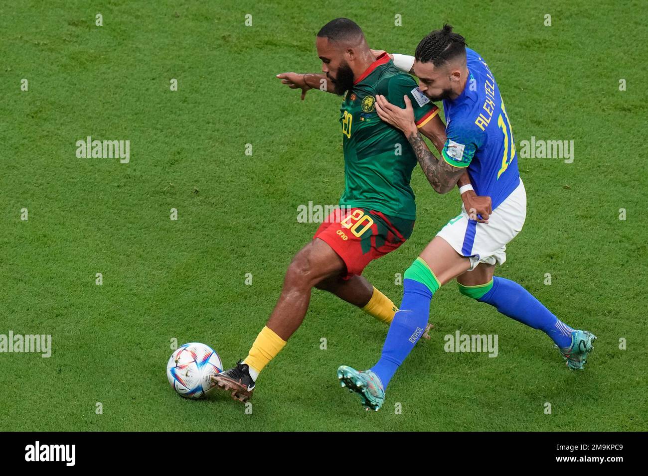 Cameroon's Bryan Mbeumo, left, is challenged by Brazil's Alex Telles ...