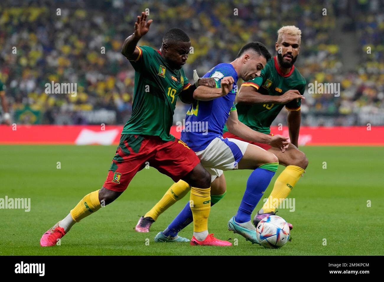 Brazil's Gabriel Martinelli, center, fights for the ball with Cameroon ...