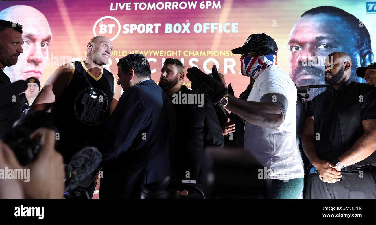 Boxer Tyson Fury the WBC heavyweight champion, left, smiles as he looks ...