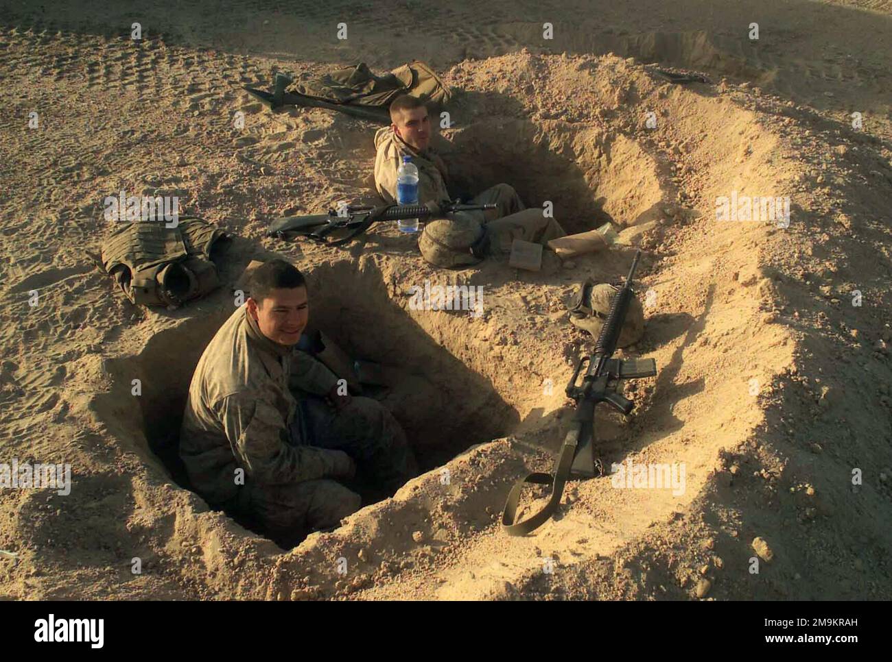 With their Colt 5.56mm M16A2 Assault Rifles nearby, US Marine Corps ...