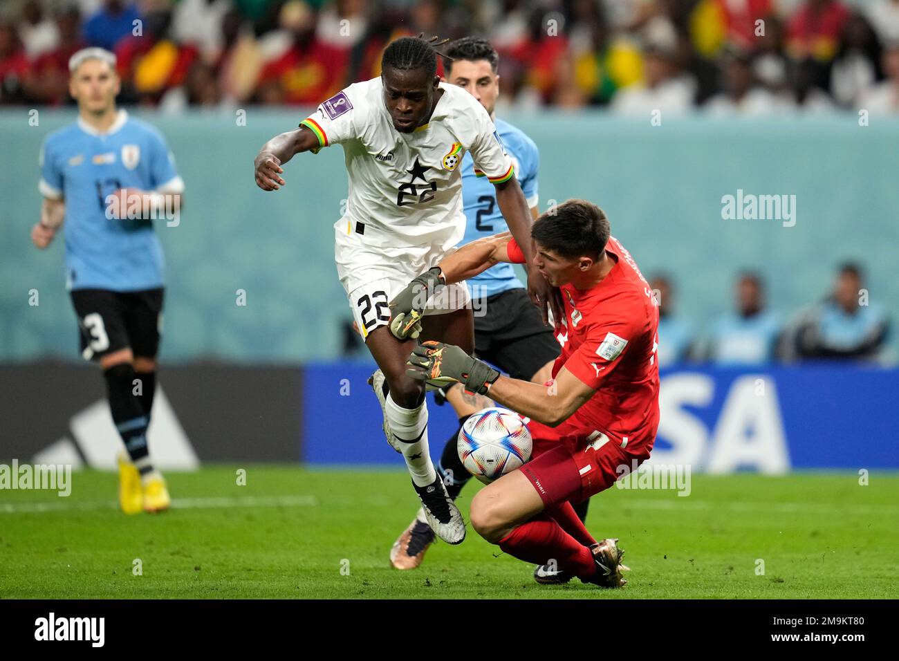 Uruguay's goalkeeper Sergio Rochet, right, makes a save against Ghana's ...