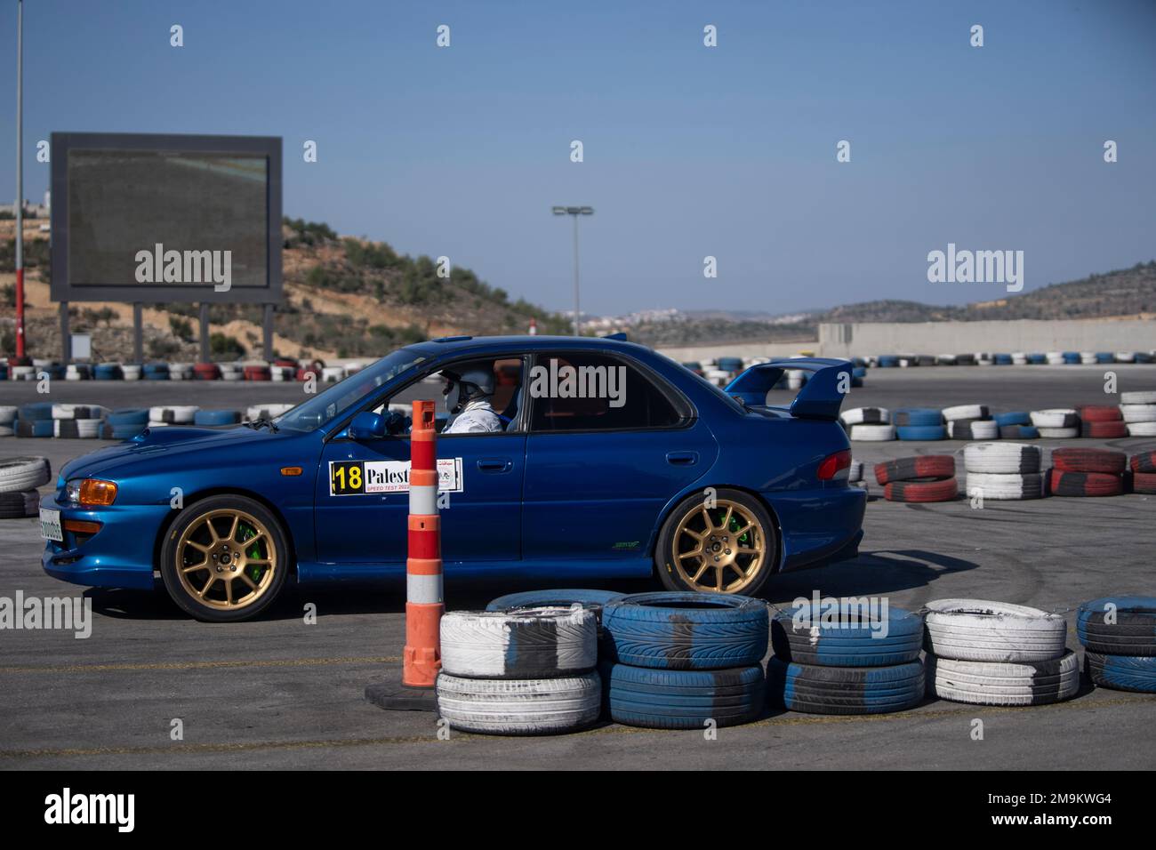 Palestinian Abdullah Naseef rides in a race car during the fifth and ...