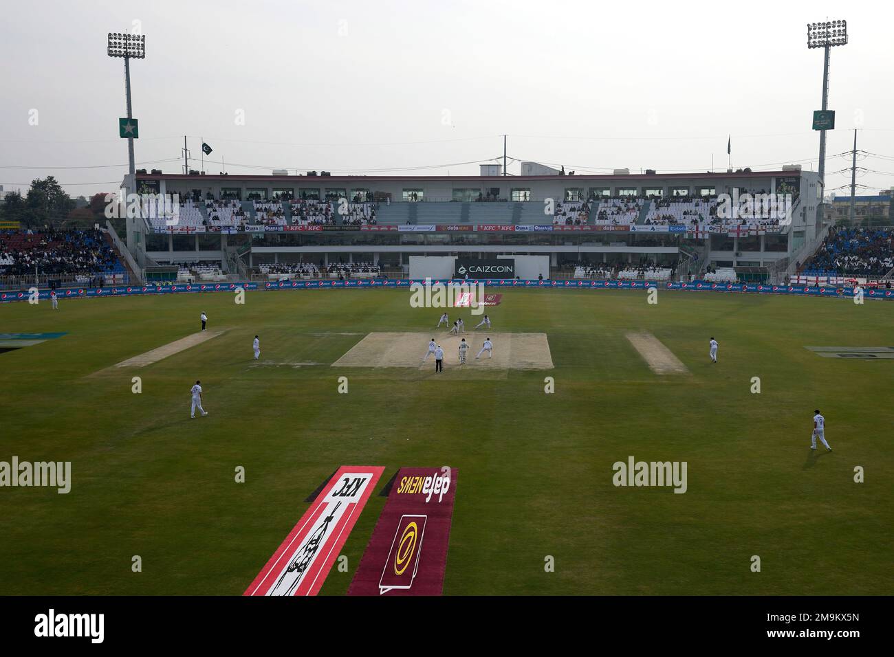 People watch the second day game of the first test cricket match ...