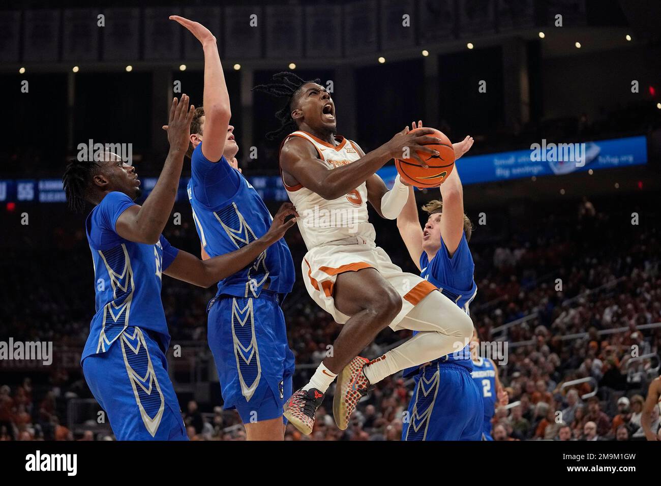 Texas guard Marcus Carr (5) drives to the basket past Creighton center ...