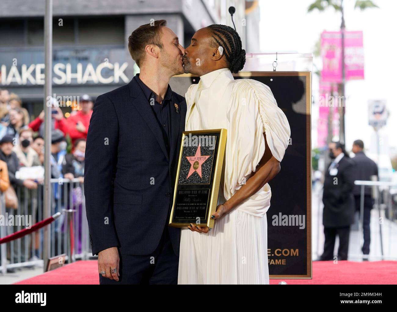 Actor Billy Porter, right, gets a kiss from his husband Adam Smith ...